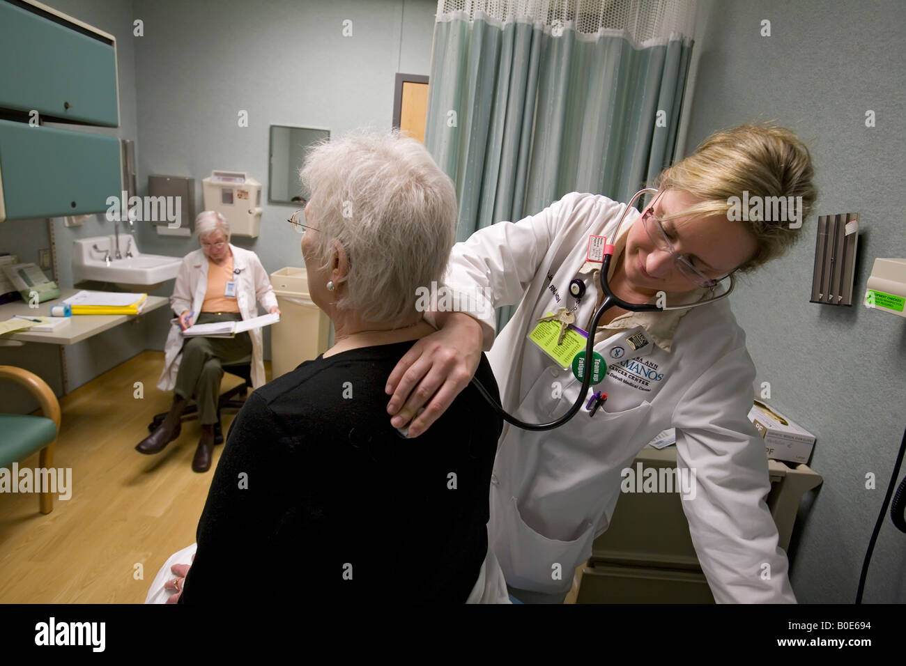 Nurse practitioner examines patient participating in clinical trial of ...