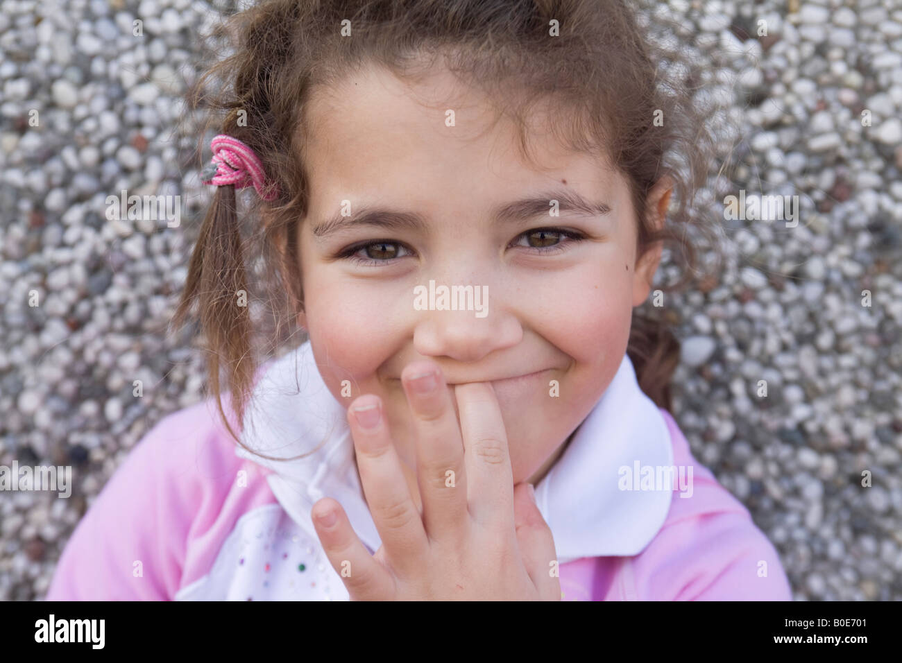 Funny little girl with finger in her mouth Stock Photo - Alamy