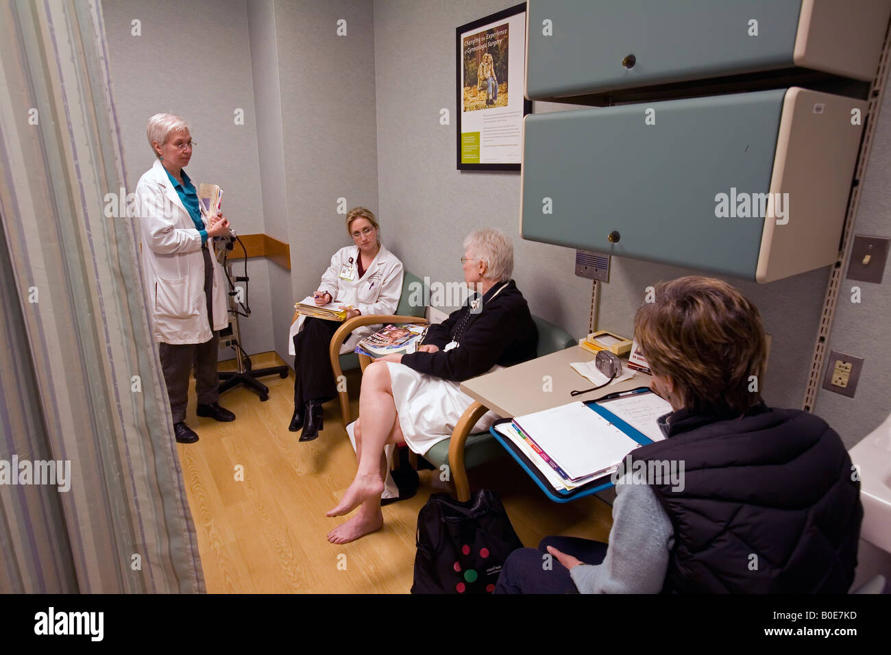 Nurse practitioner and research nurse talk to patient participating in ...