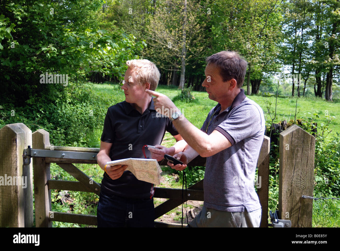 Two men walking and plotting route with GPS Stock Photo - Alamy