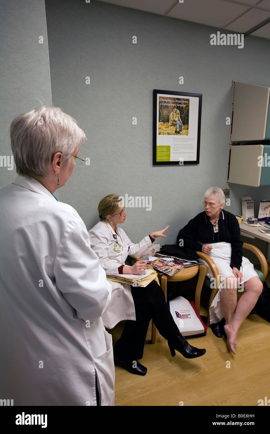 Nurse practitioner and research nurse talk to patient participating in ...