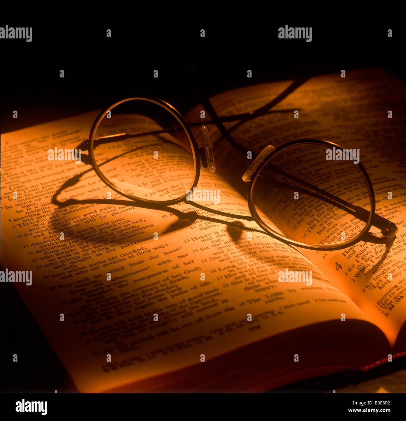 Reading glasses rest atop a Bible Stock Photo - Alamy