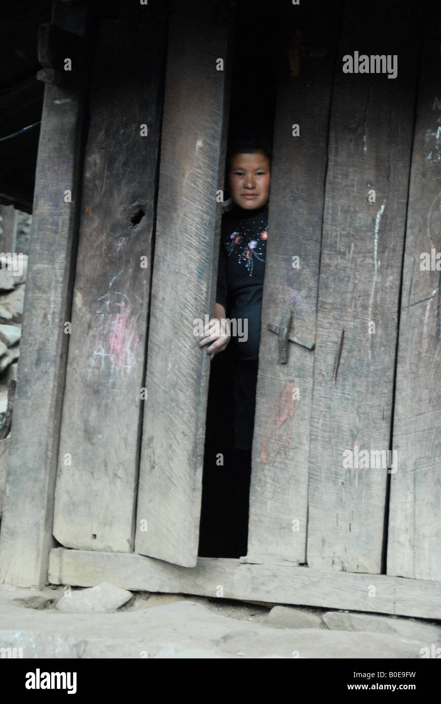 black hmong lady behind close door, sin chi Stock Photo - Alamy