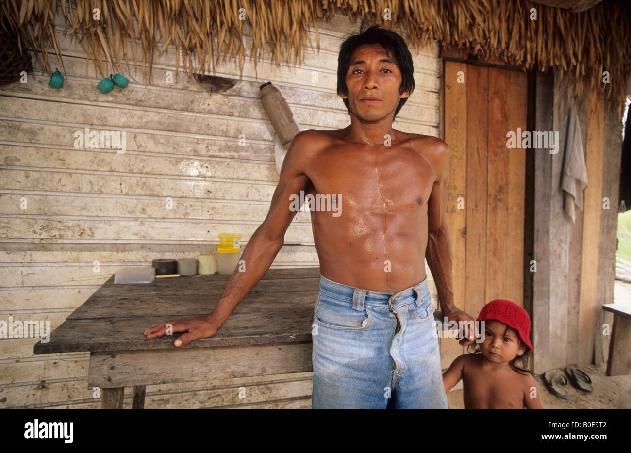 fisherman infront of his basic house in a remote Amazonian community in ...
