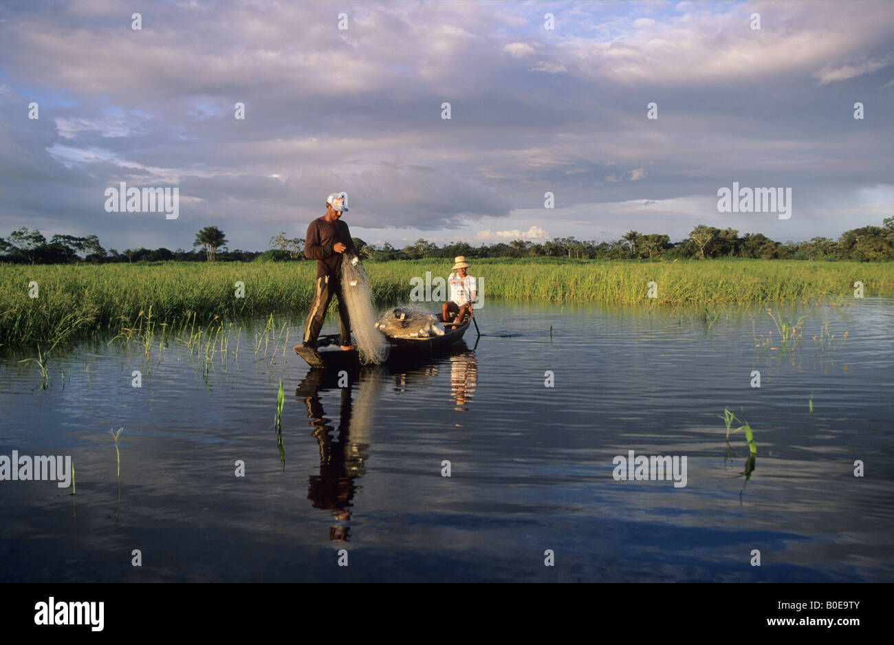 Fishermen about to lay nets in the flooded forest (varzea) on the river ...