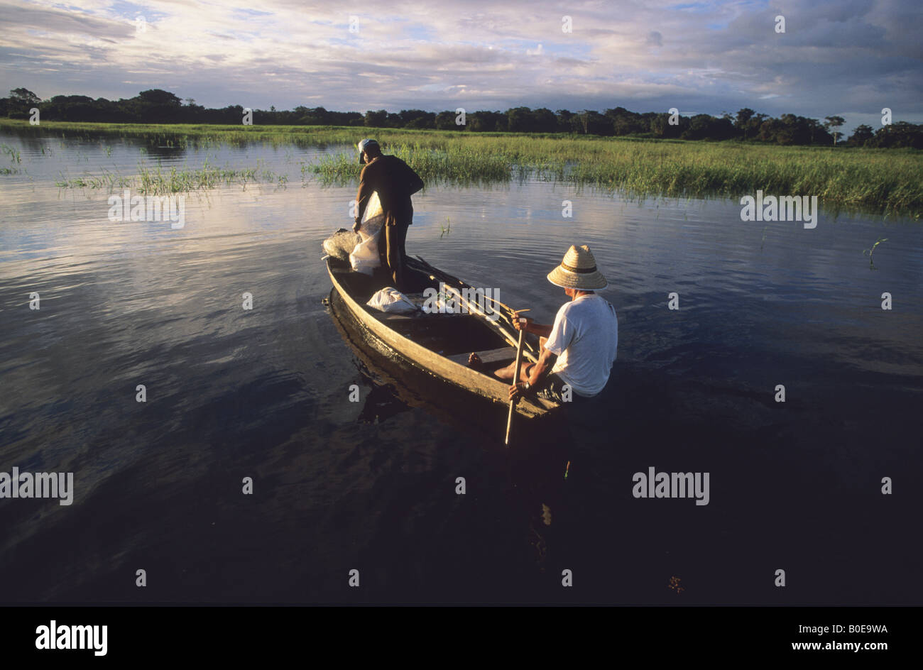 Fishermen about to lay nets in the flooded forest (varzea) on the river ...