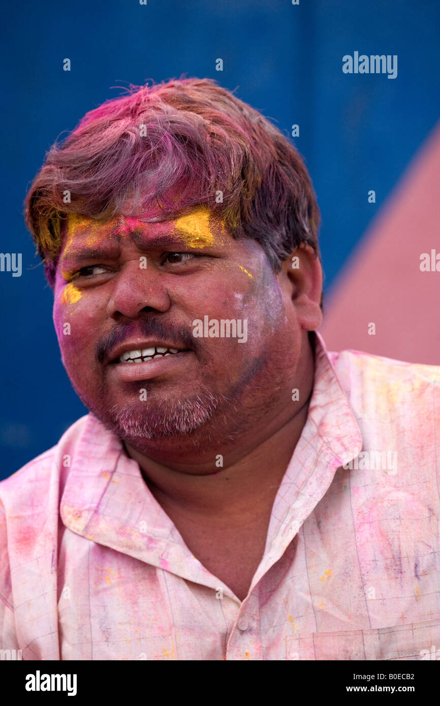A man is smeared with coloured powder in the Paharganj Market of Delhi ...