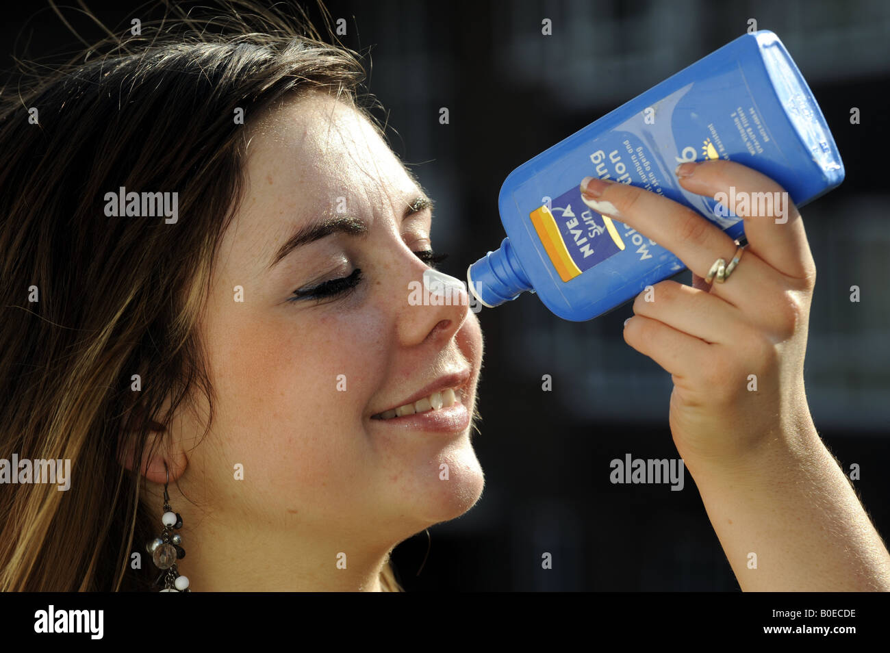 Woman applies sun cream hi-res stock photography and images - Alamy