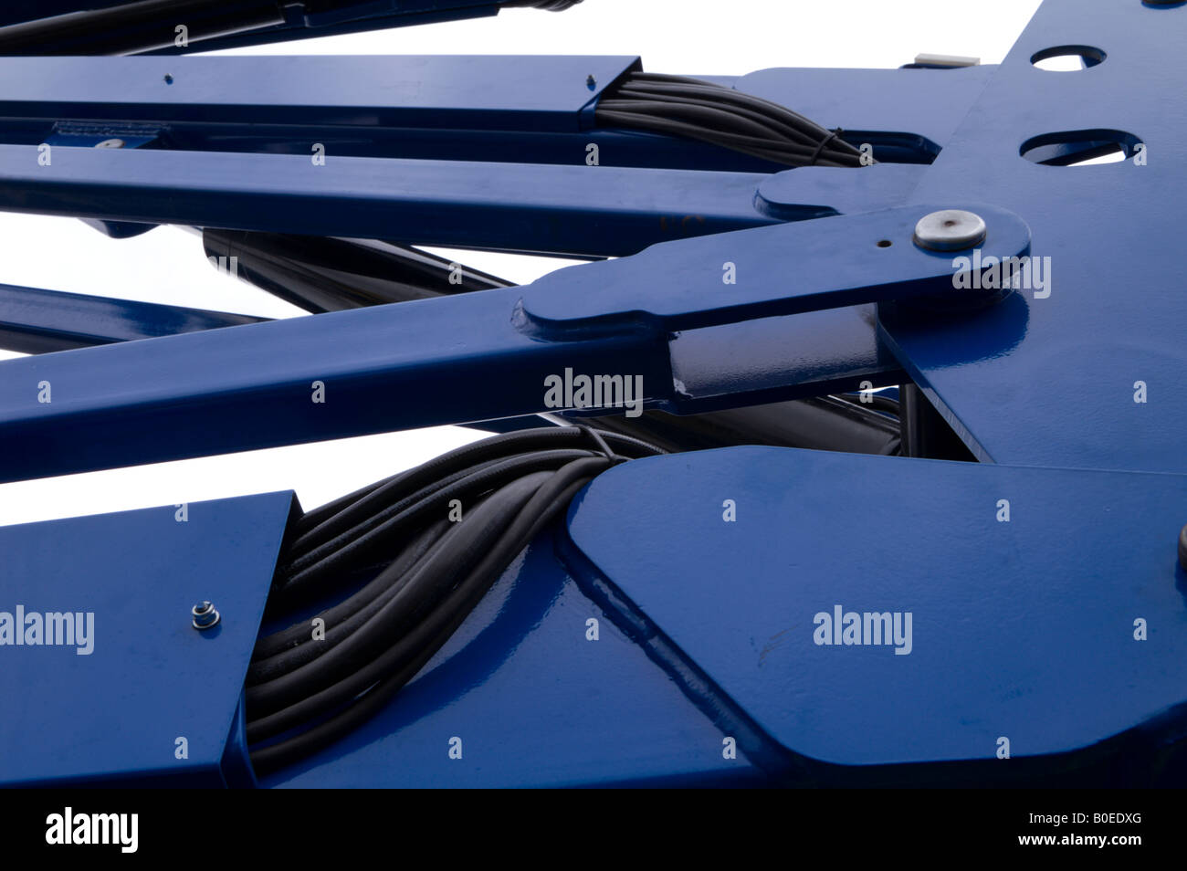 Plant machinery - hydraulic pipes and linkages on a rising platform ...