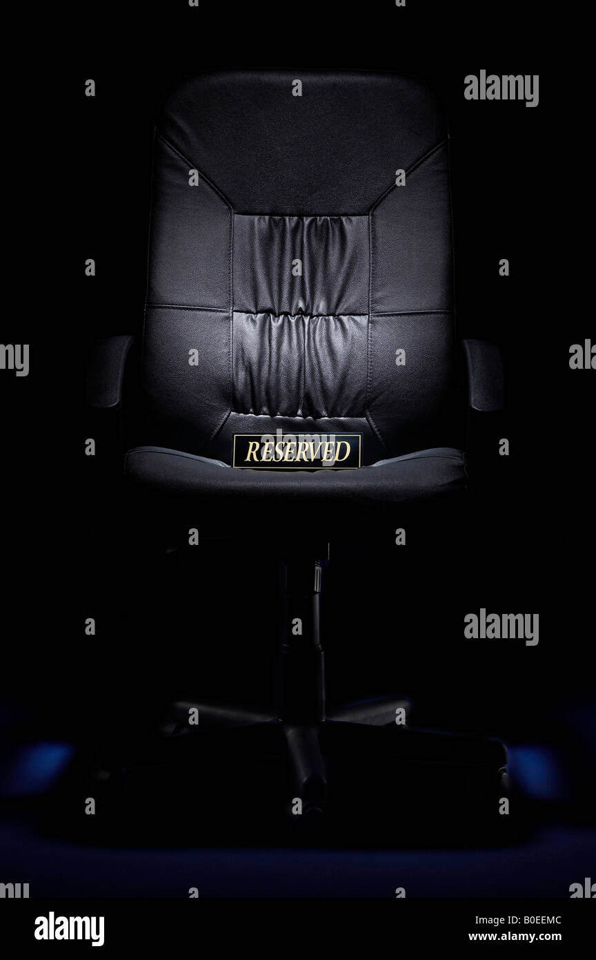 Reserved sign on office chair Stock Photo - Alamy