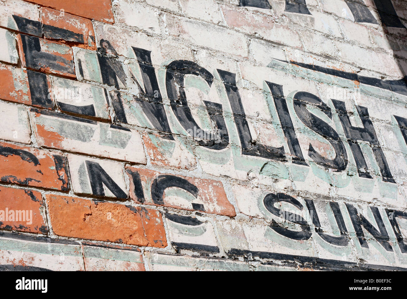 English sign painted on red brick wall Stock Photo - Alamy