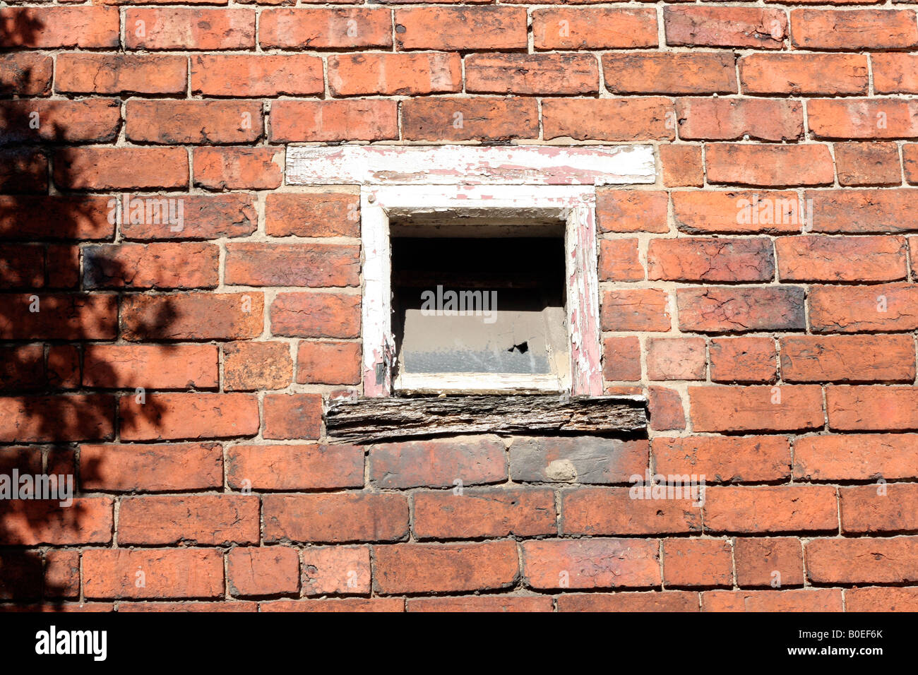 Small broken window in red brick wall Stock Photo - Alamy