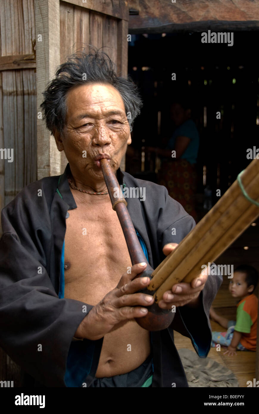 Old Lahu hill tribe man playing a traditional flute Stock Photo - Alamy