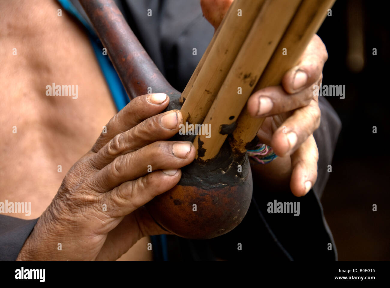Old Lahu hill tribe man playing a traditional flute Stock Photo - Alamy