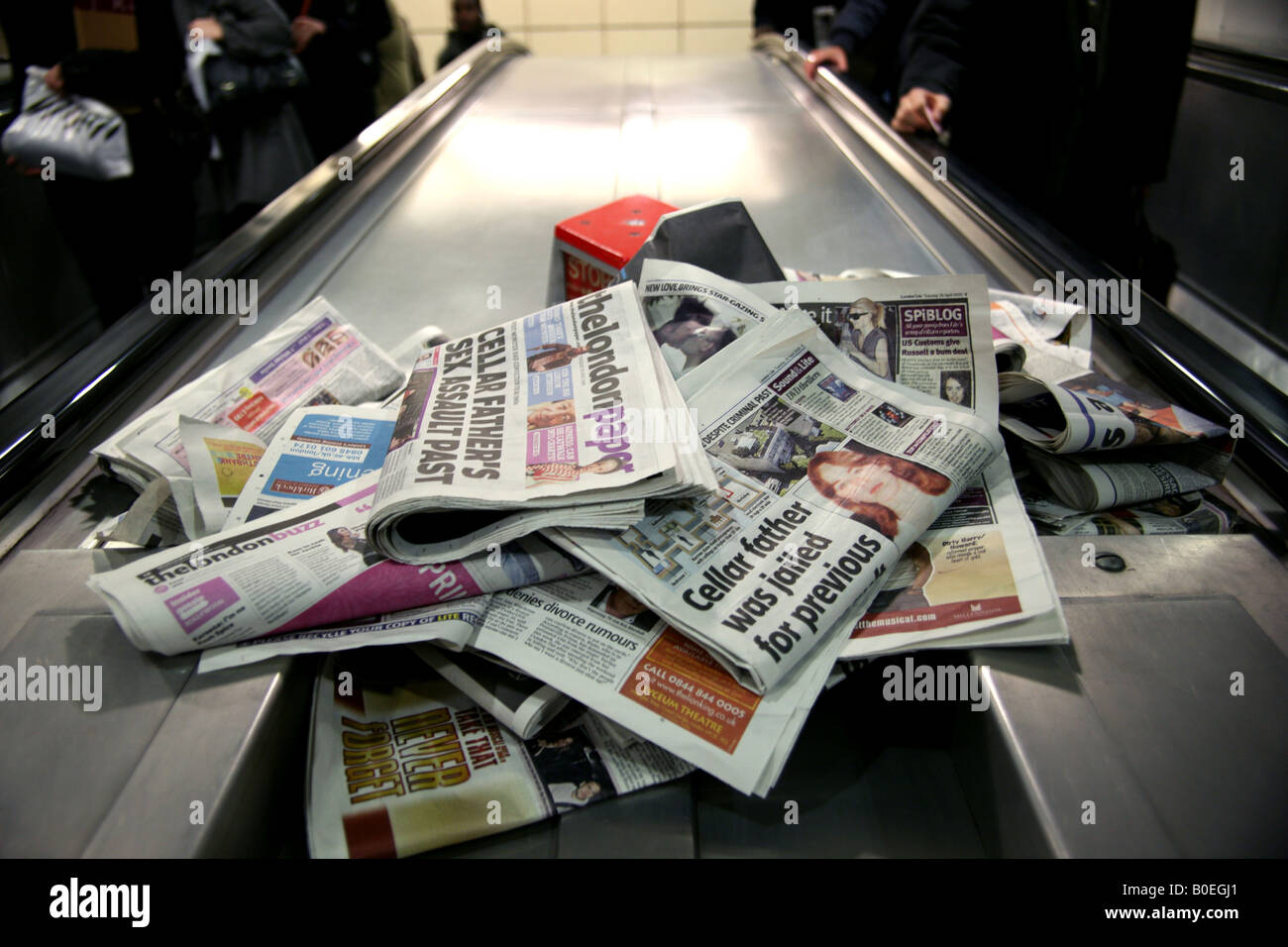 Discarded free London newspapers at top of tube escalators Stock Photo ...