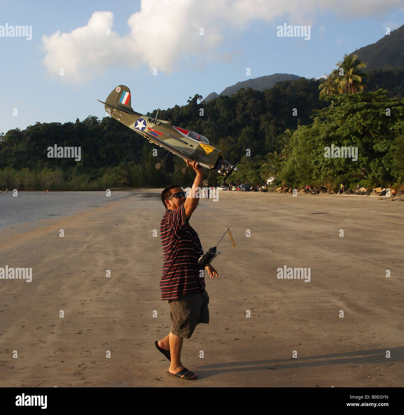 A man carrying a model aircraft on the beach Stock Photo - Alamy