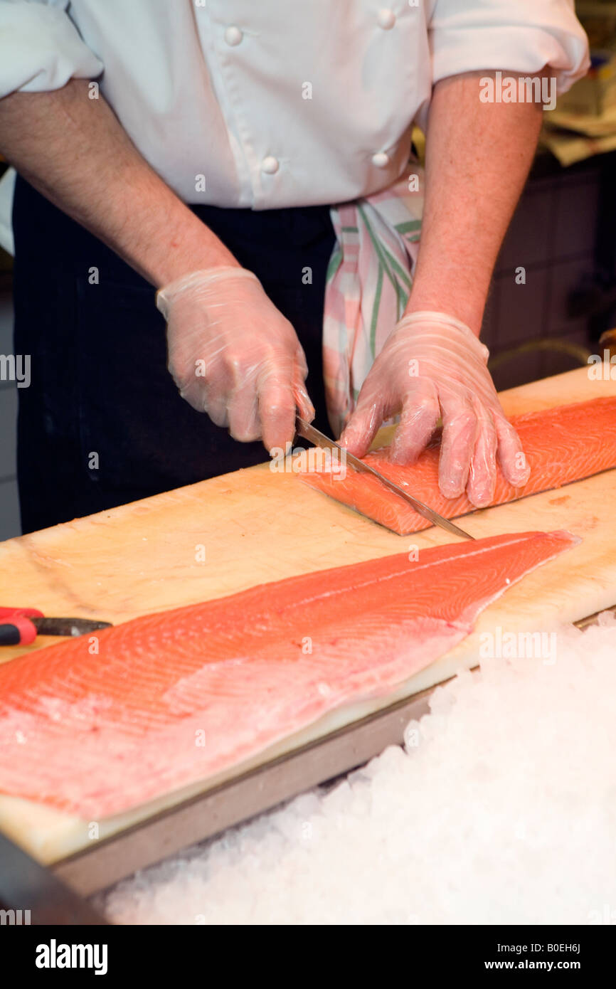 A chef cuts and trims salmon fillets Stock Photo - Alamy
