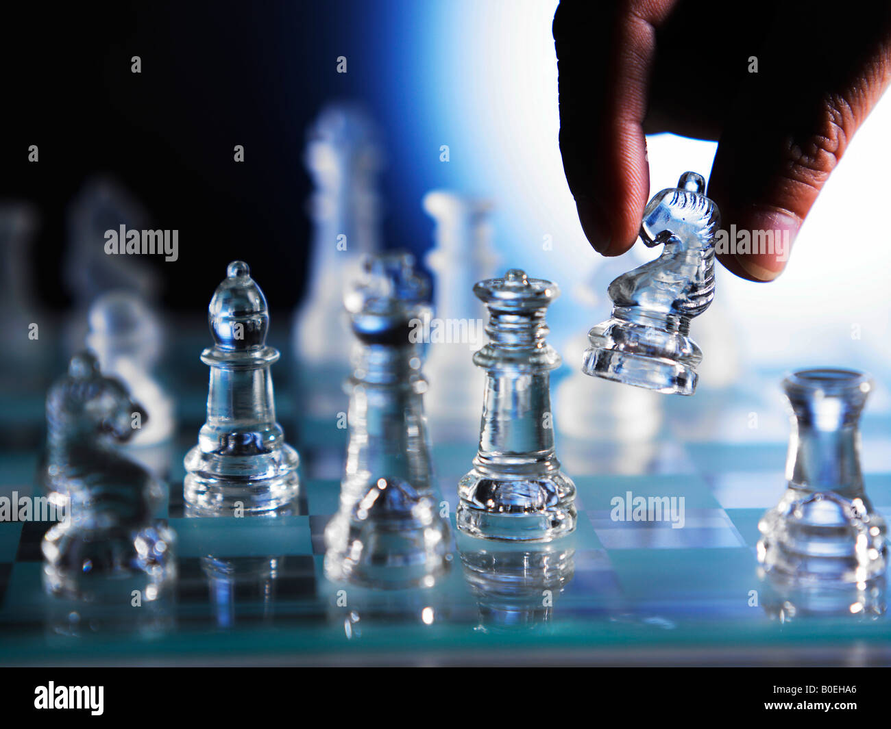 A hand moving a knight Stock Photo - Alamy