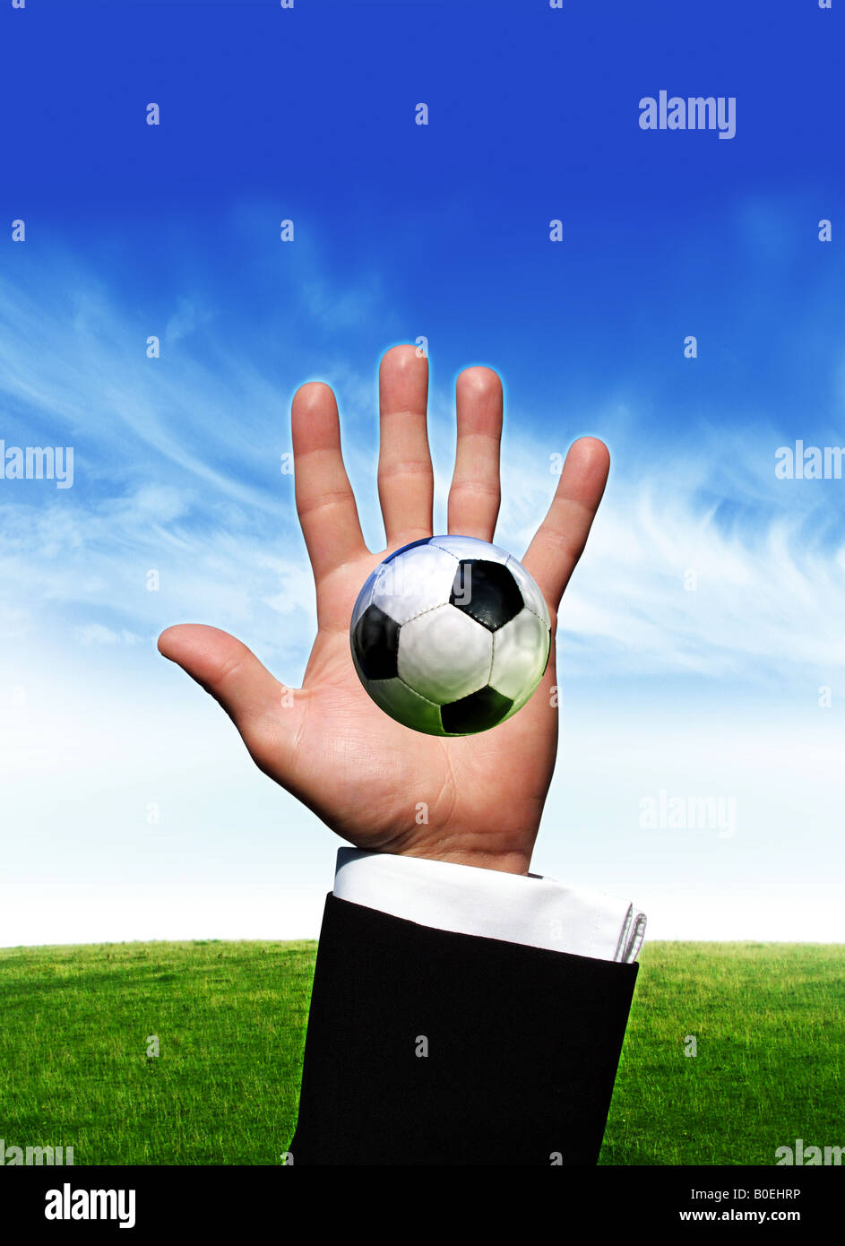 Football in hand Stock Photo - Alamy