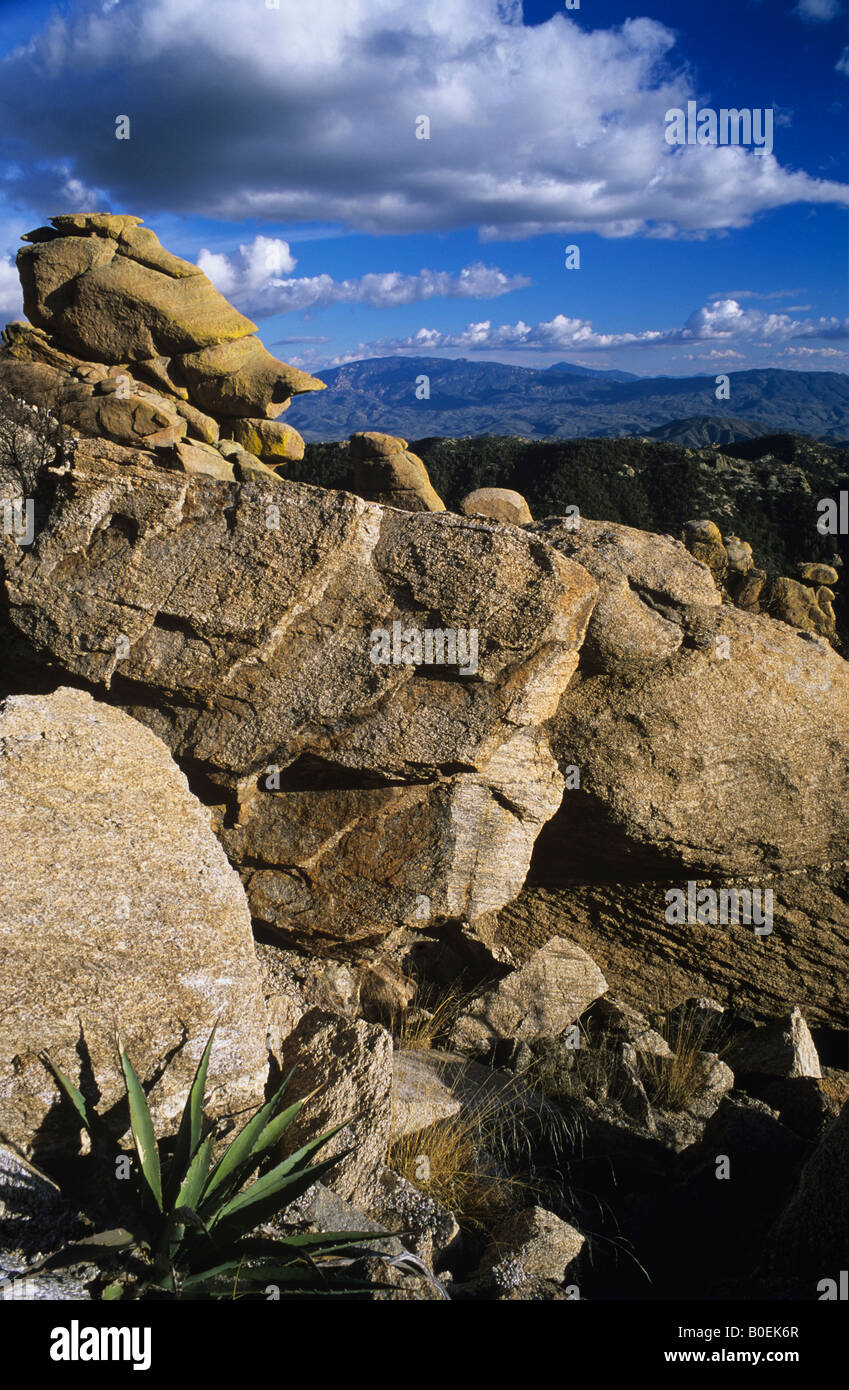 A head shaped rock formation against a dramatic blue sky with white ...