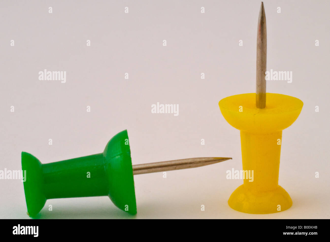 Yellow and green drawing pins View from the side. Close up (macro Stock ...