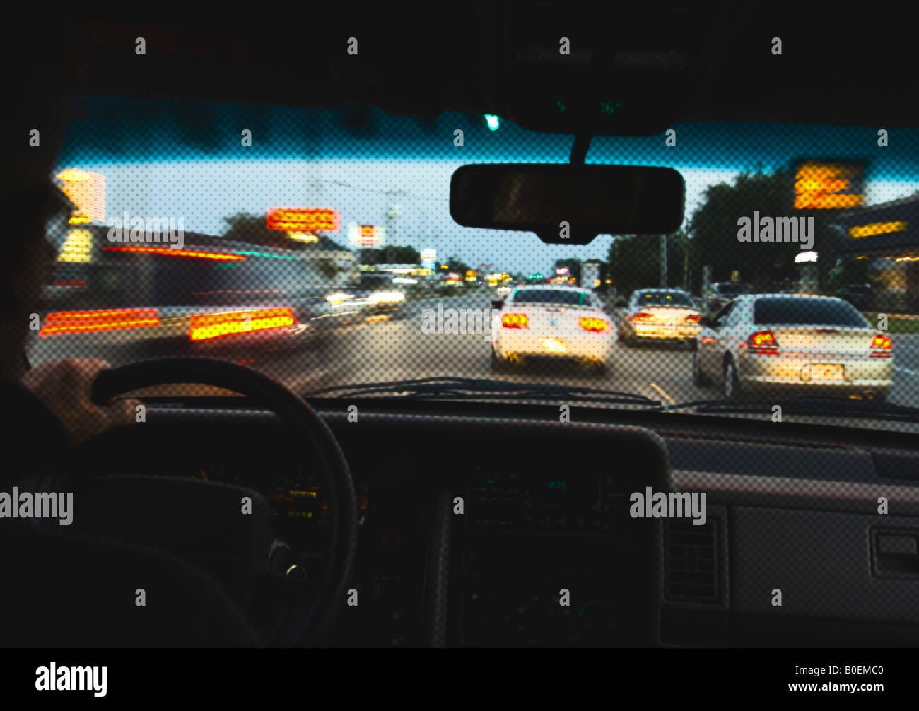 night traffic congestion seen through windshield textured with halftone ...
