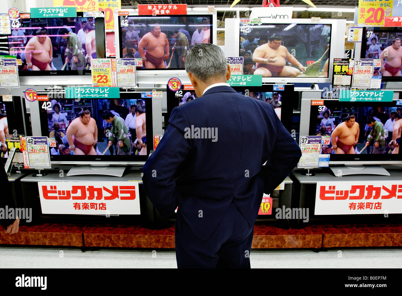 A salaryman watching sumo Stock Photo - Alamy