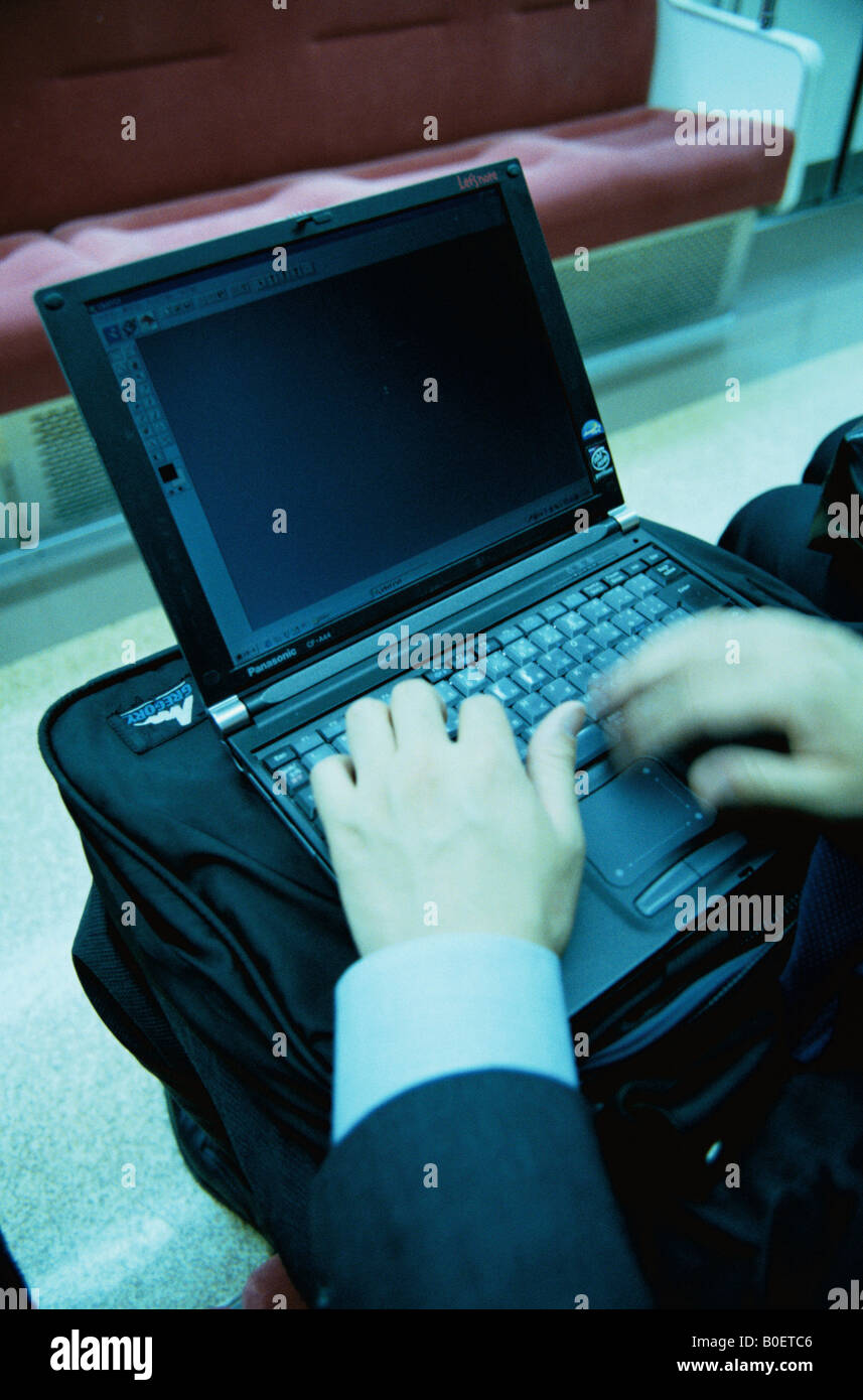 Man With Laptop On Train Stock Photo - Alamy