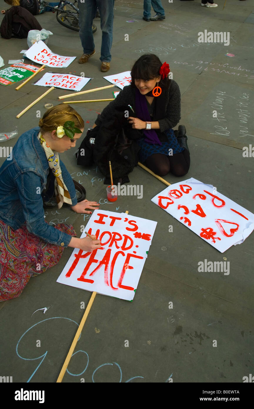 Girl painting a banner at a peace rally at Trafalgar Square in London ...