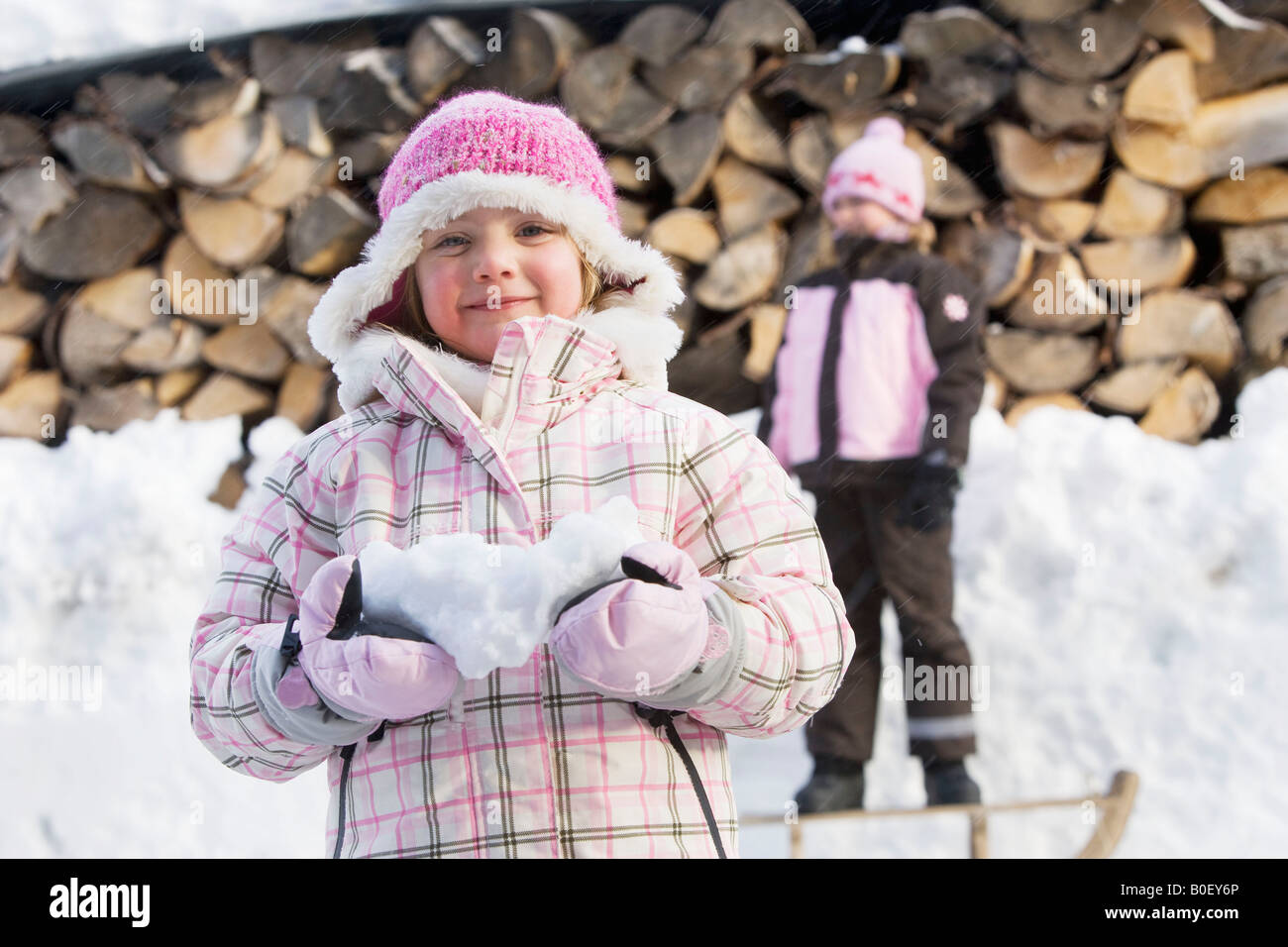 Young girls having fun in the snow Stock Photo - Alamy
