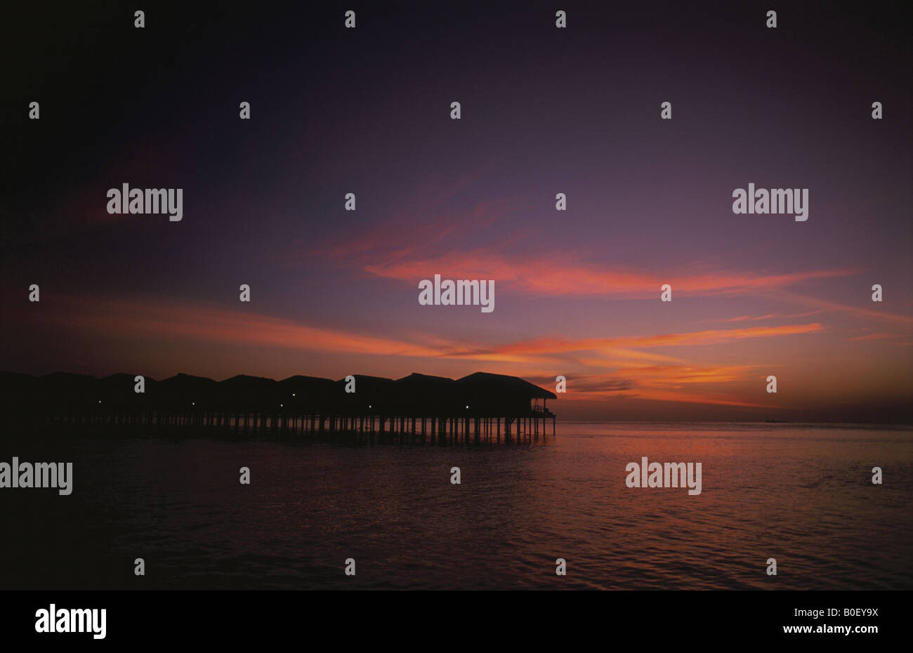 The Silhouette Of The Setting Sun And The Cottage Stock Photo - Alamy