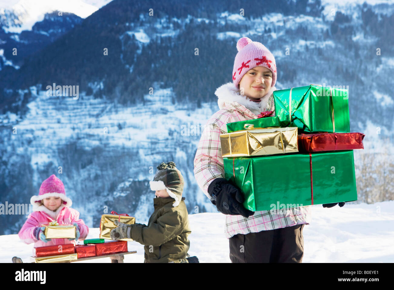 Children with presents in the snow Stock Photo - Alamy