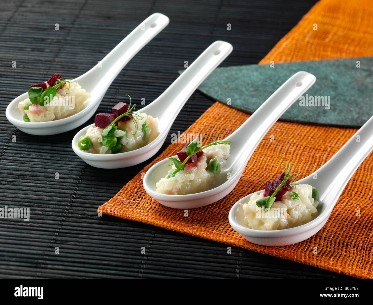 Ham and pea risotto in Chinese spoons editorial food Stock Photo - Alamy