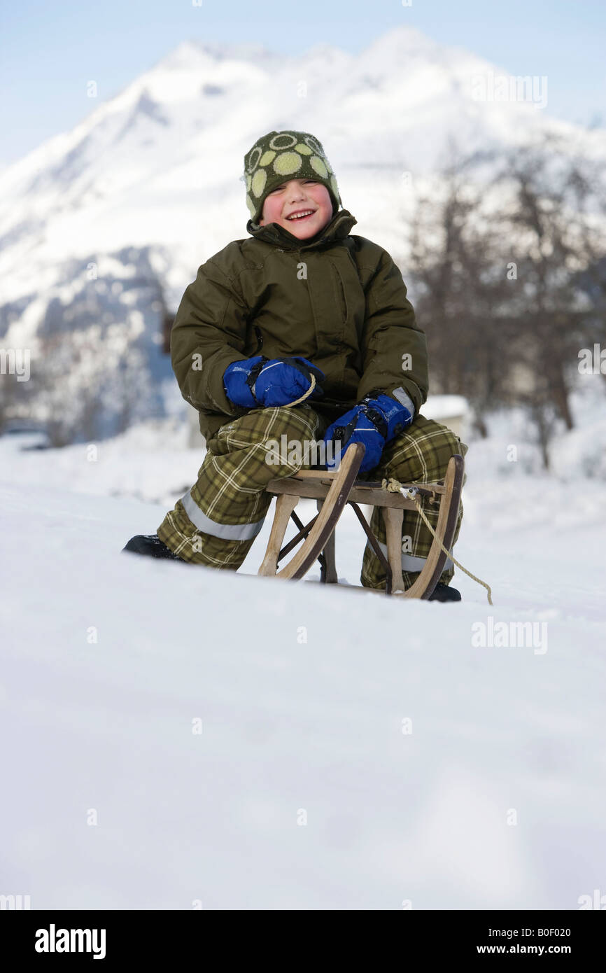 Boy on sitting sledge Stock Photo - Alamy
