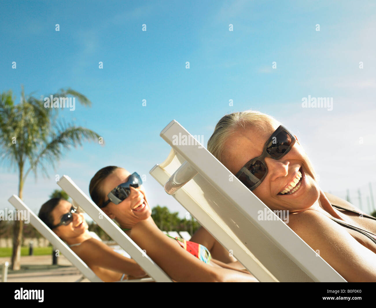 Three women sun tanning in hi-res stock photography and images - Alamy