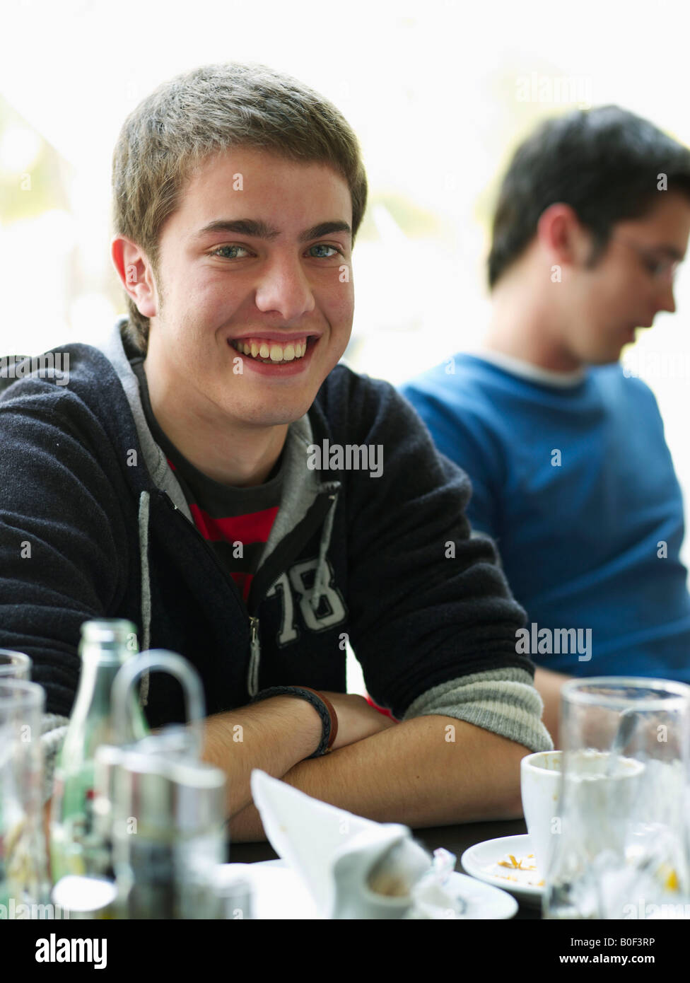 Portrait of teenage male sitting in cafe Stock Photo - Alamy