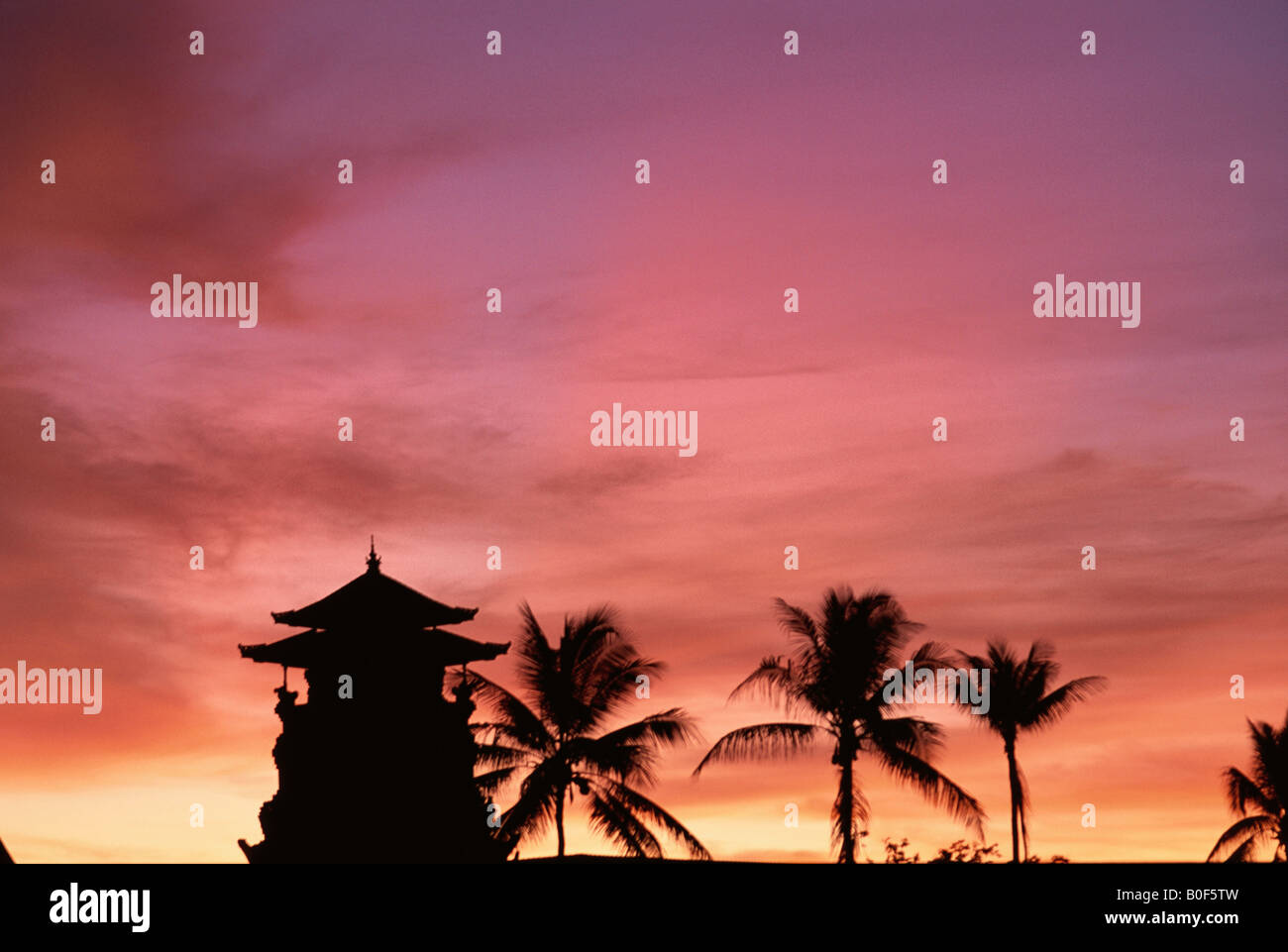Pagoda And Palms At Sunset Stock Photo - Alamy