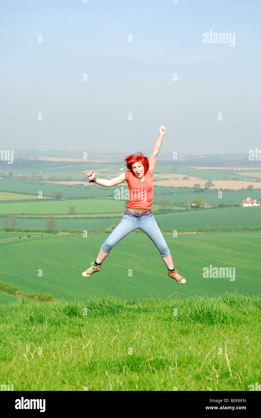 Teenager Jumping Arms Stretched Stock Photo - Alamy