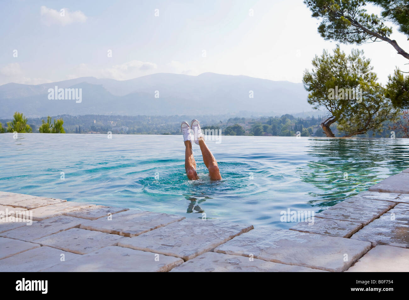 Young man diving into a pool Stock Photo - Alamy