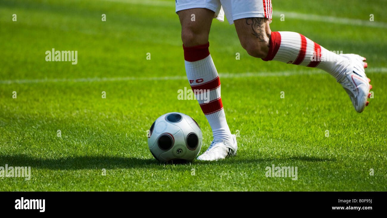 feet and boots of football player and original Europass football Stock ...