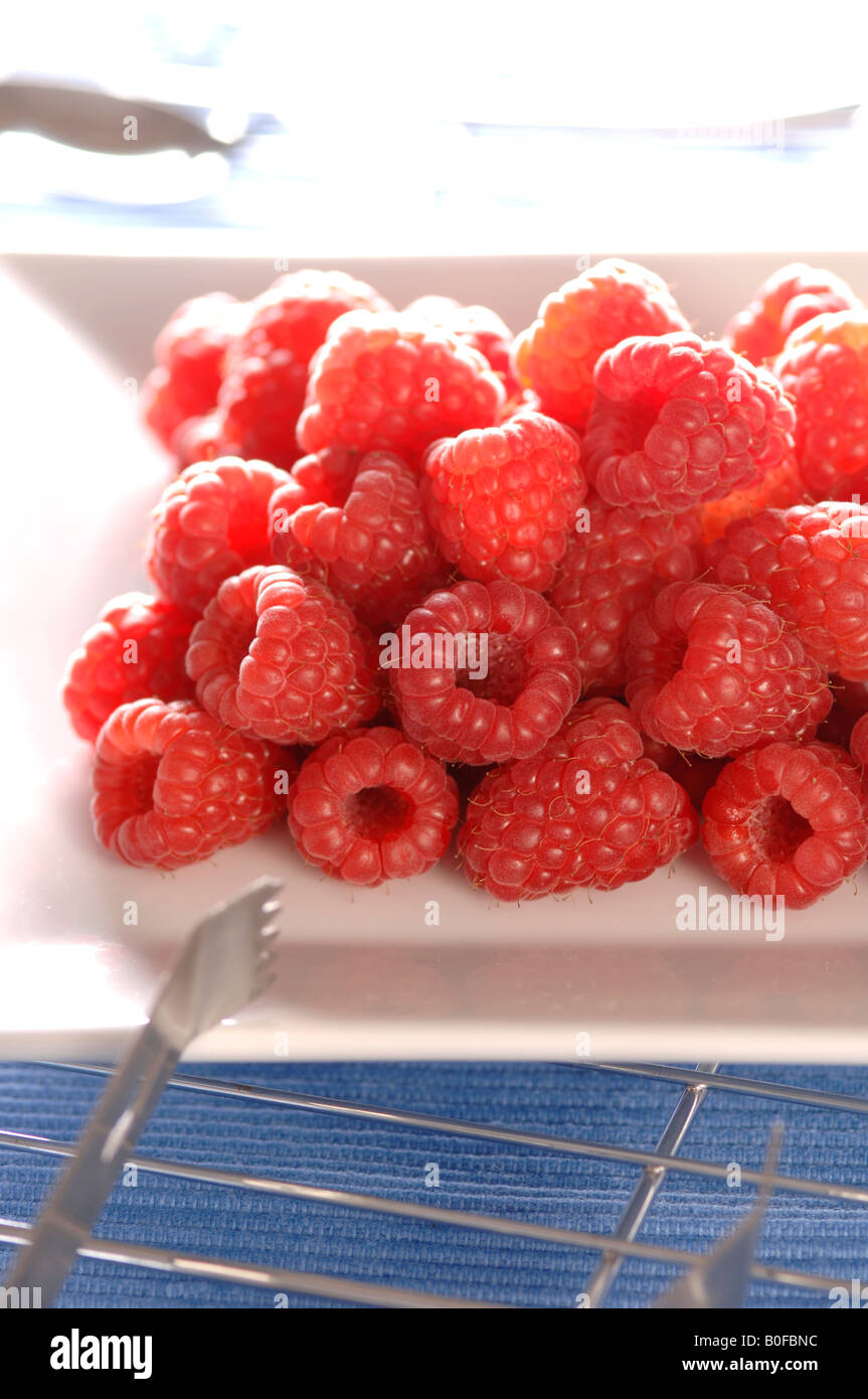 raspberries on a white dish Stock Photo - Alamy