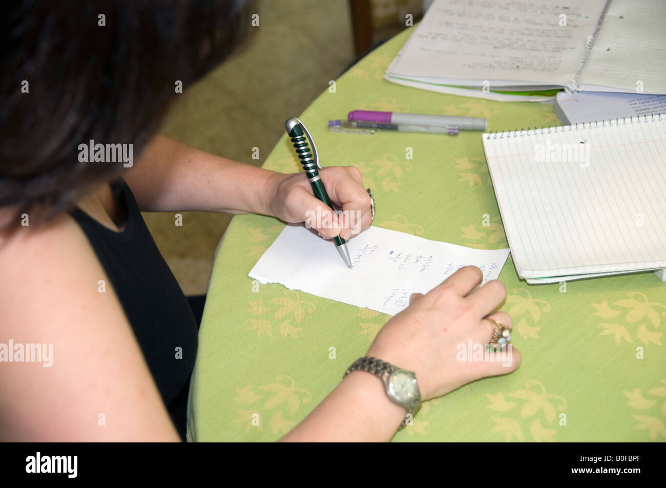 woman writing a note Model release available Stock Photo - Alamy