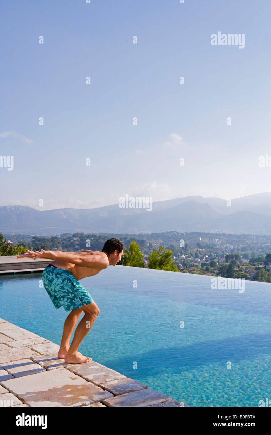 Young man diving into a pool Stock Photo - Alamy