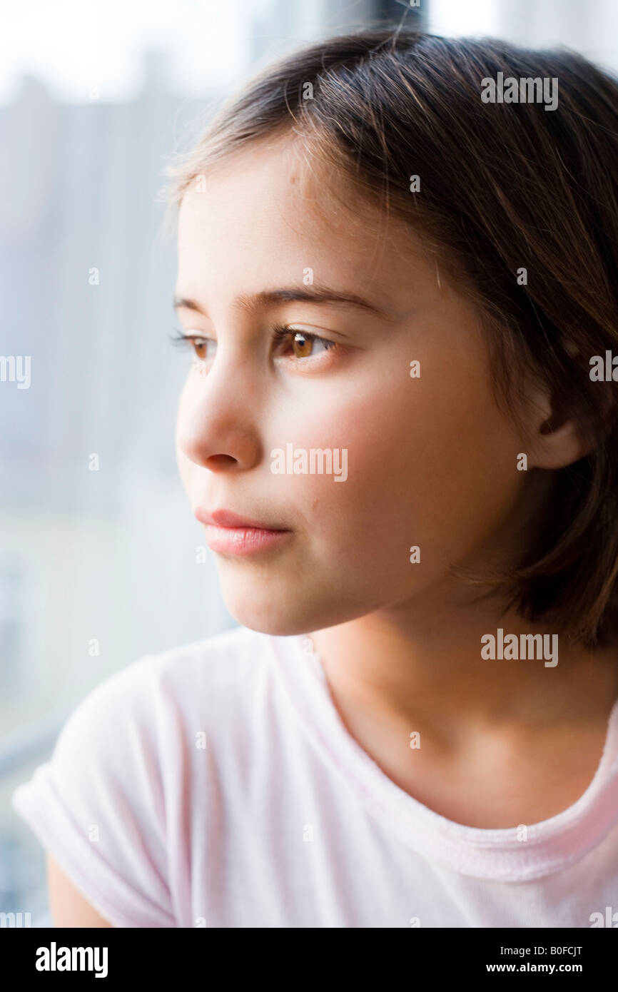 Girl looking out of window Stock Photo - Alamy