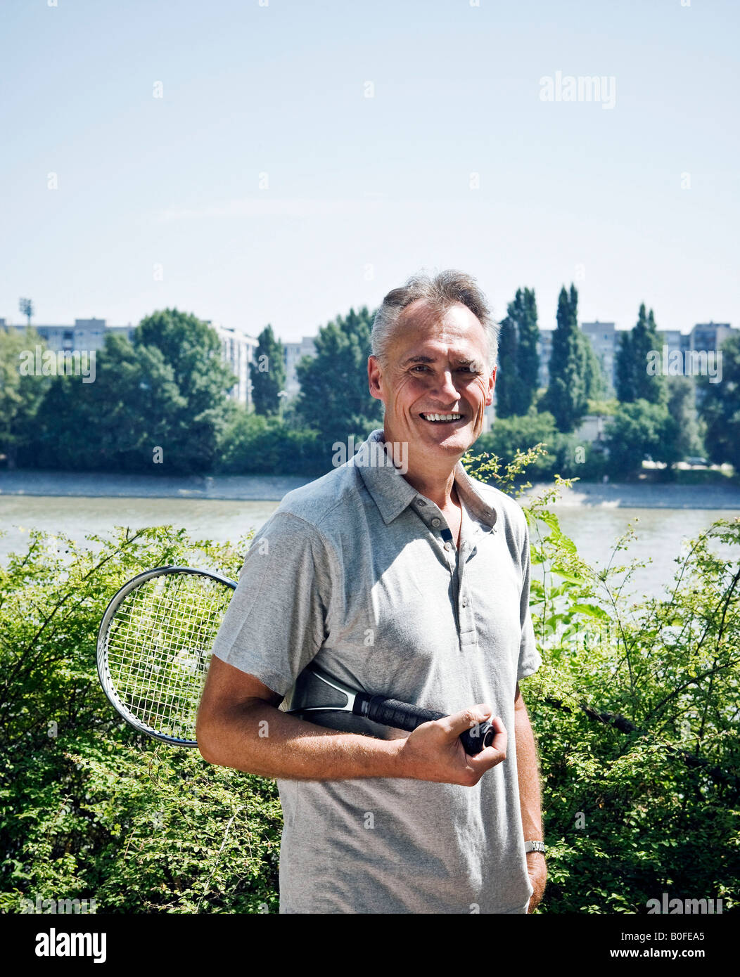 Man with tennis racket portrait Stock Photo - Alamy