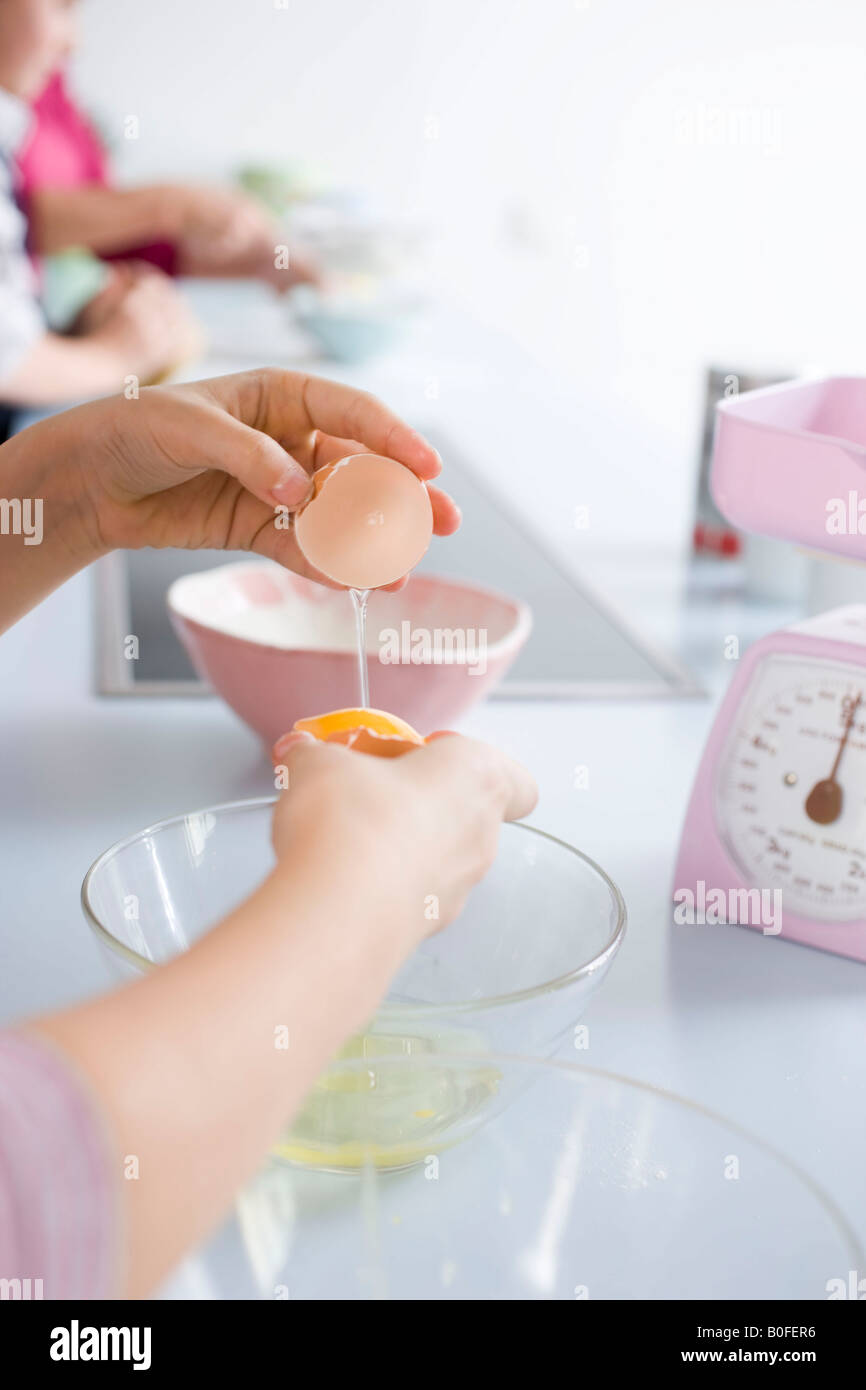 Girl separating egg yolk and egg white Stock Photo - Alamy