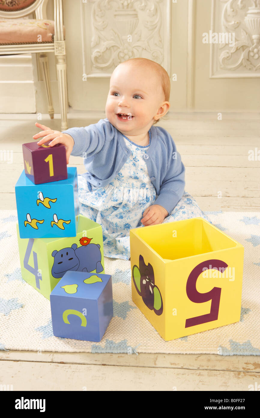 a baby pays on the floor stacking cubes Stock Photo - Alamy