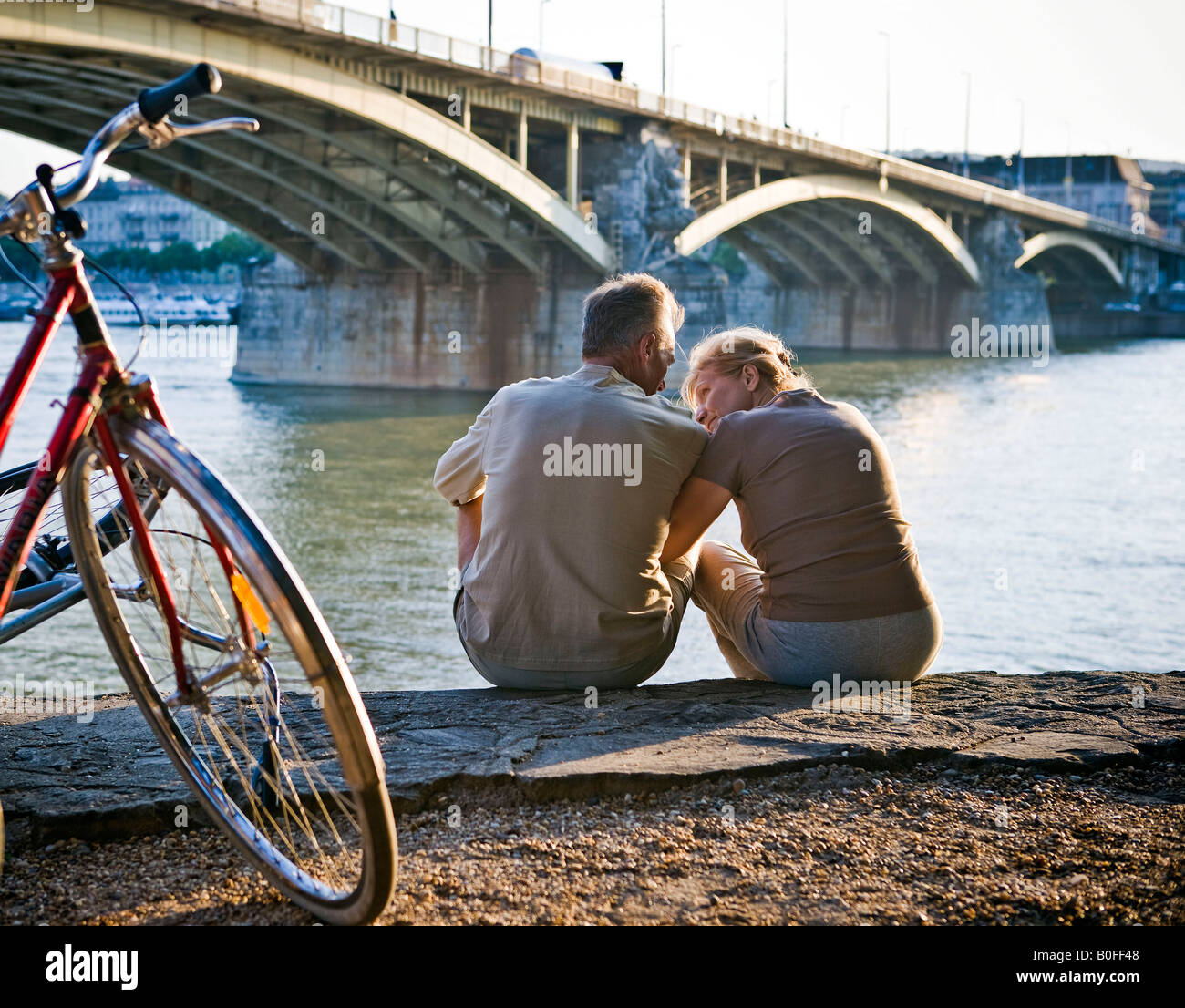 Couple by riverside Stock Photo - Alamy