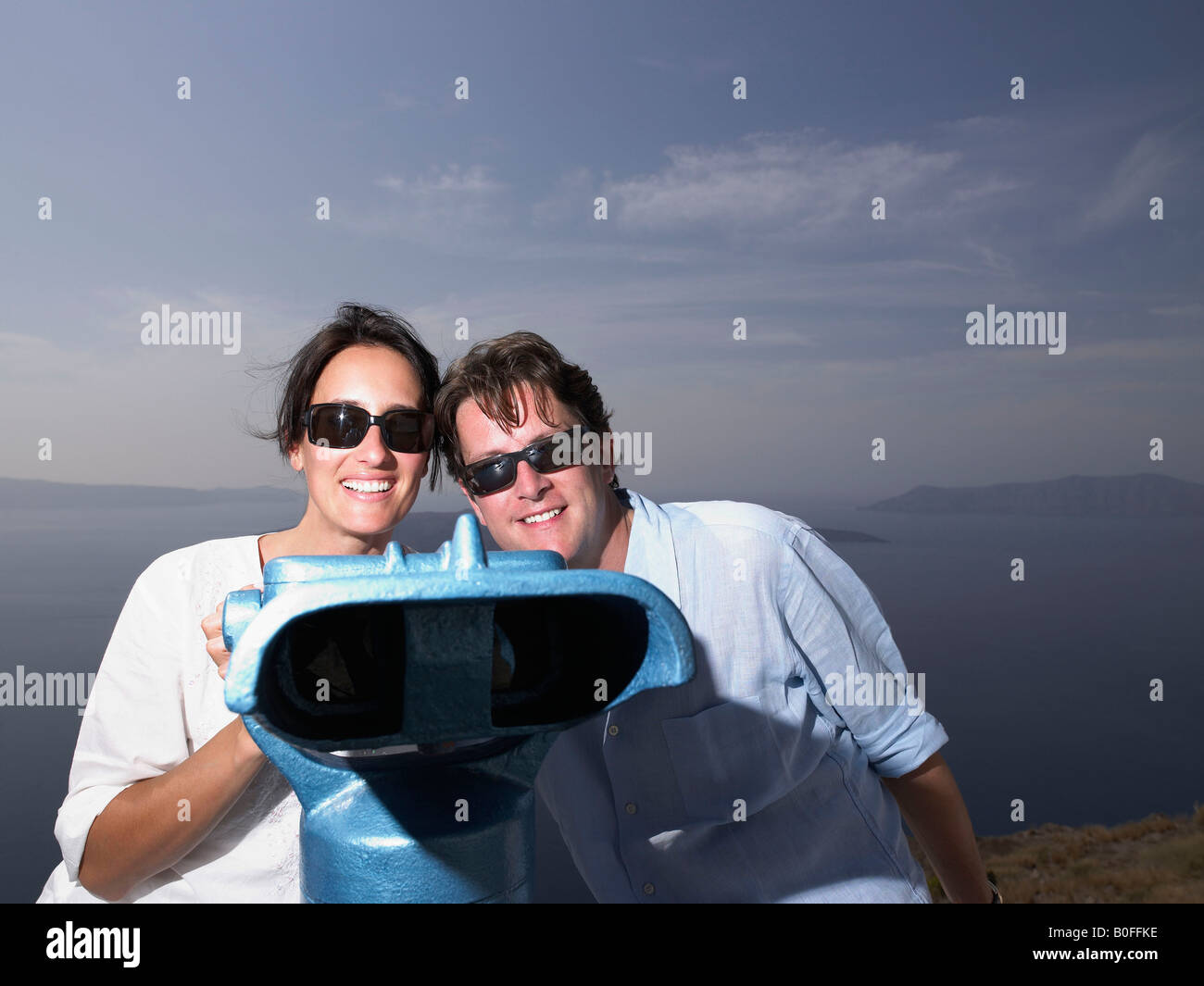 Two people looking through telescope hi-res stock photography and ...