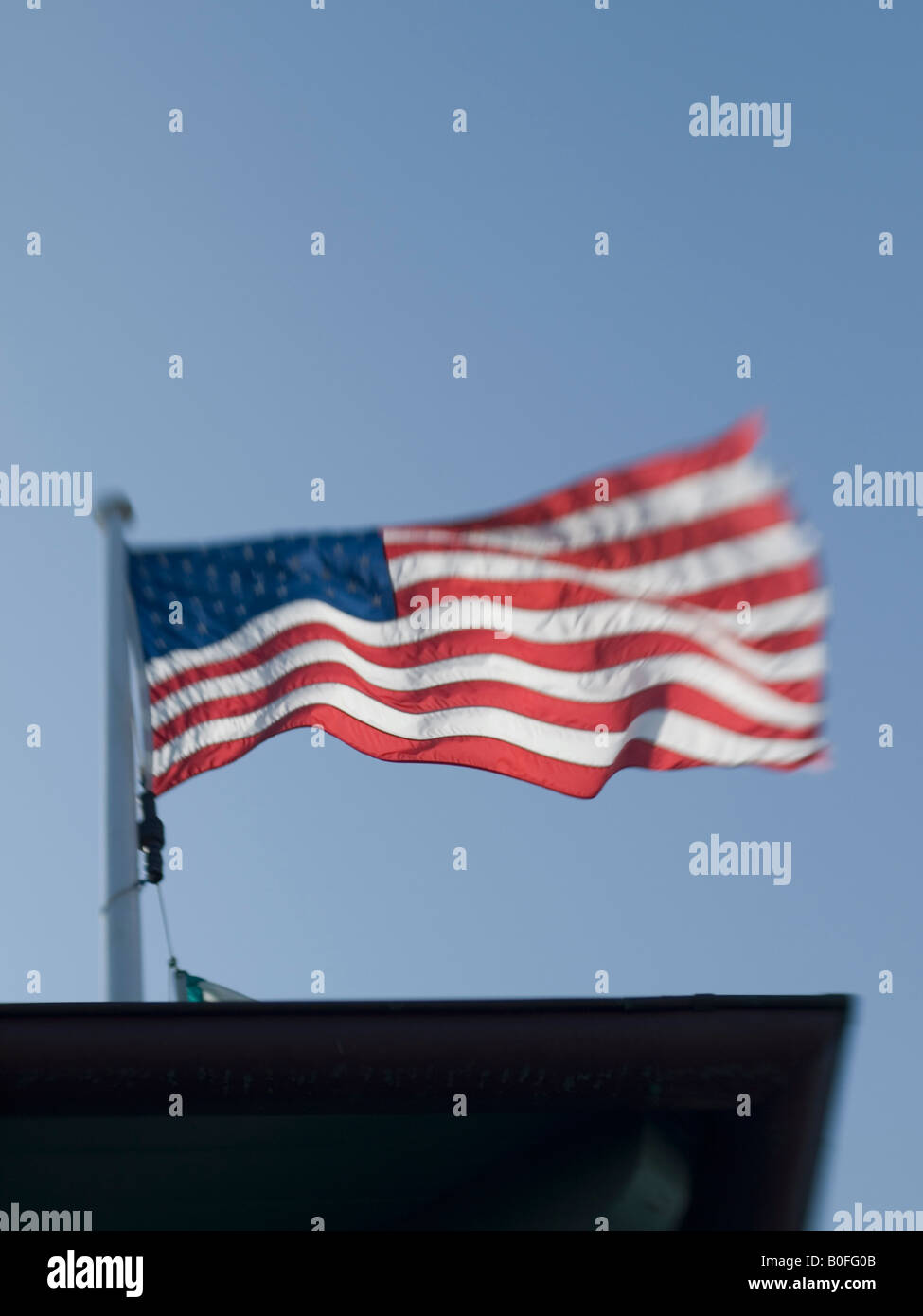 American flags flying roof hi-res stock photography and images - Alamy